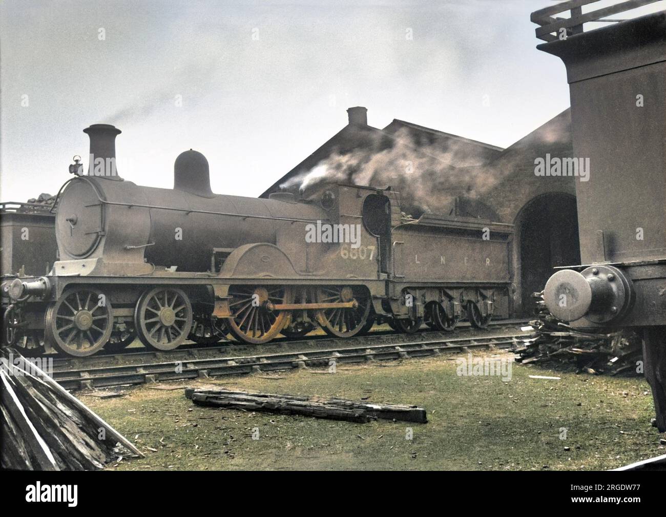 An LNER (London & North Eastern) steam engine and tender on a railway ...