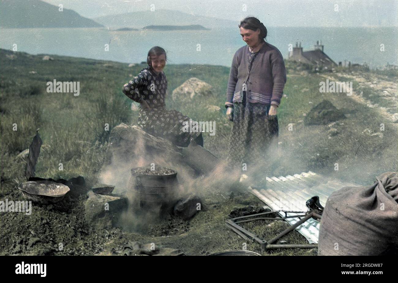 Two women with a smoking brazier in a rural landscape on the Isle of ...