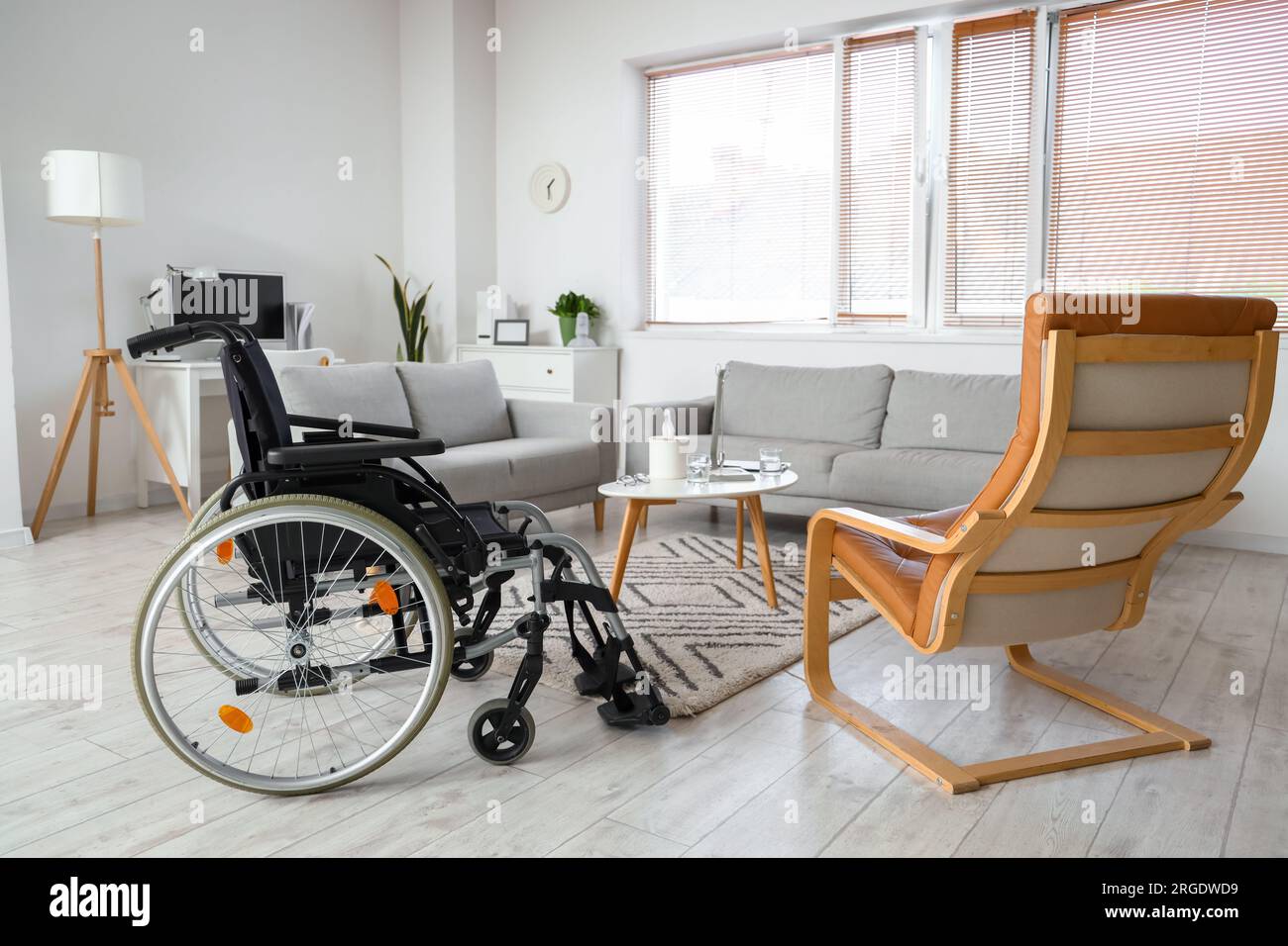 Interior of psychologist's office with wheelchair and sofas Stock Photo ...