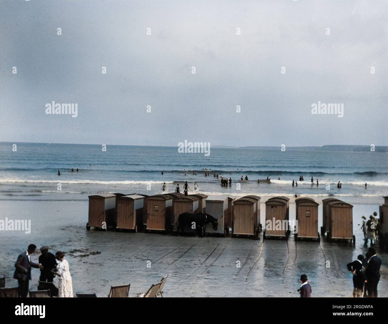 Bathing huts with wheels on the beach at Newquay, Cornwall, with a few ...