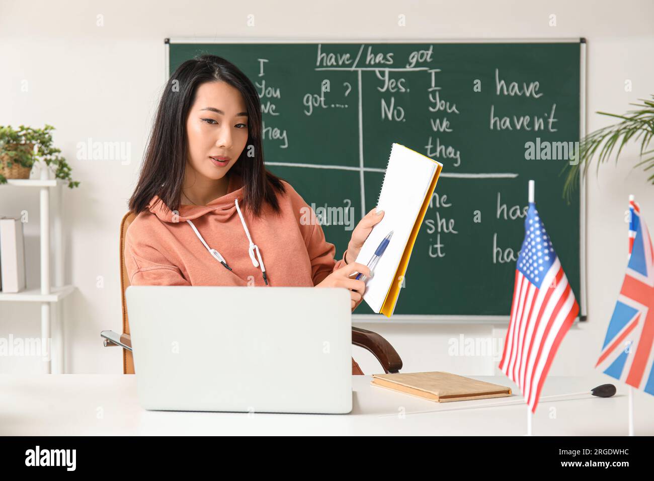 Female English teacher giving online grammar lesson in classroom Stock ...