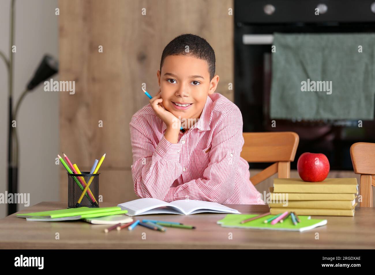 Little African-American boy doing homework in kitchen Stock Photo - Alamy