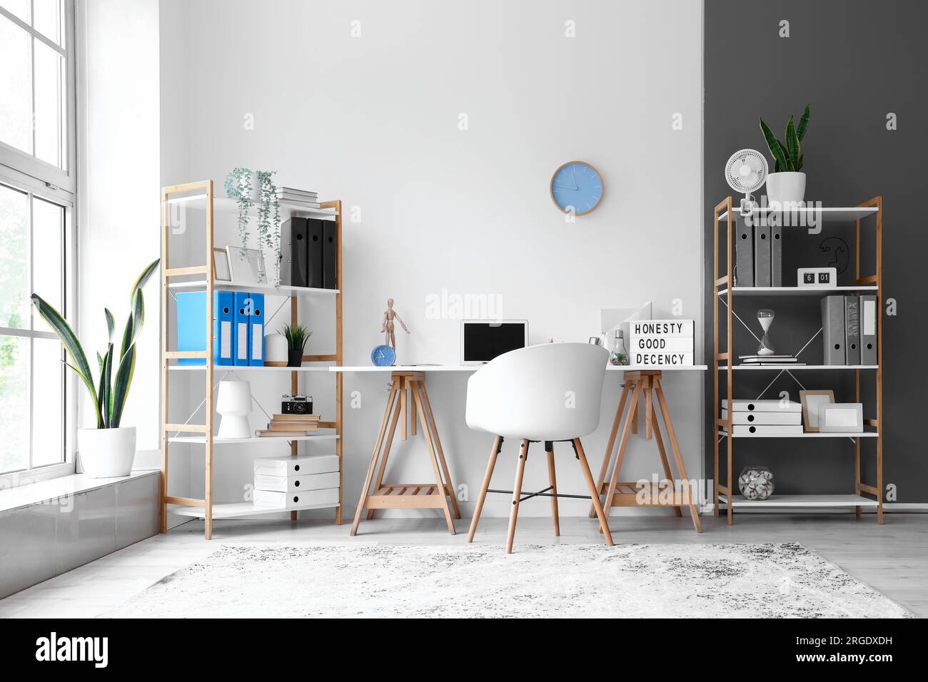 Interior of light office with modern workplace and shelving units Stock ...