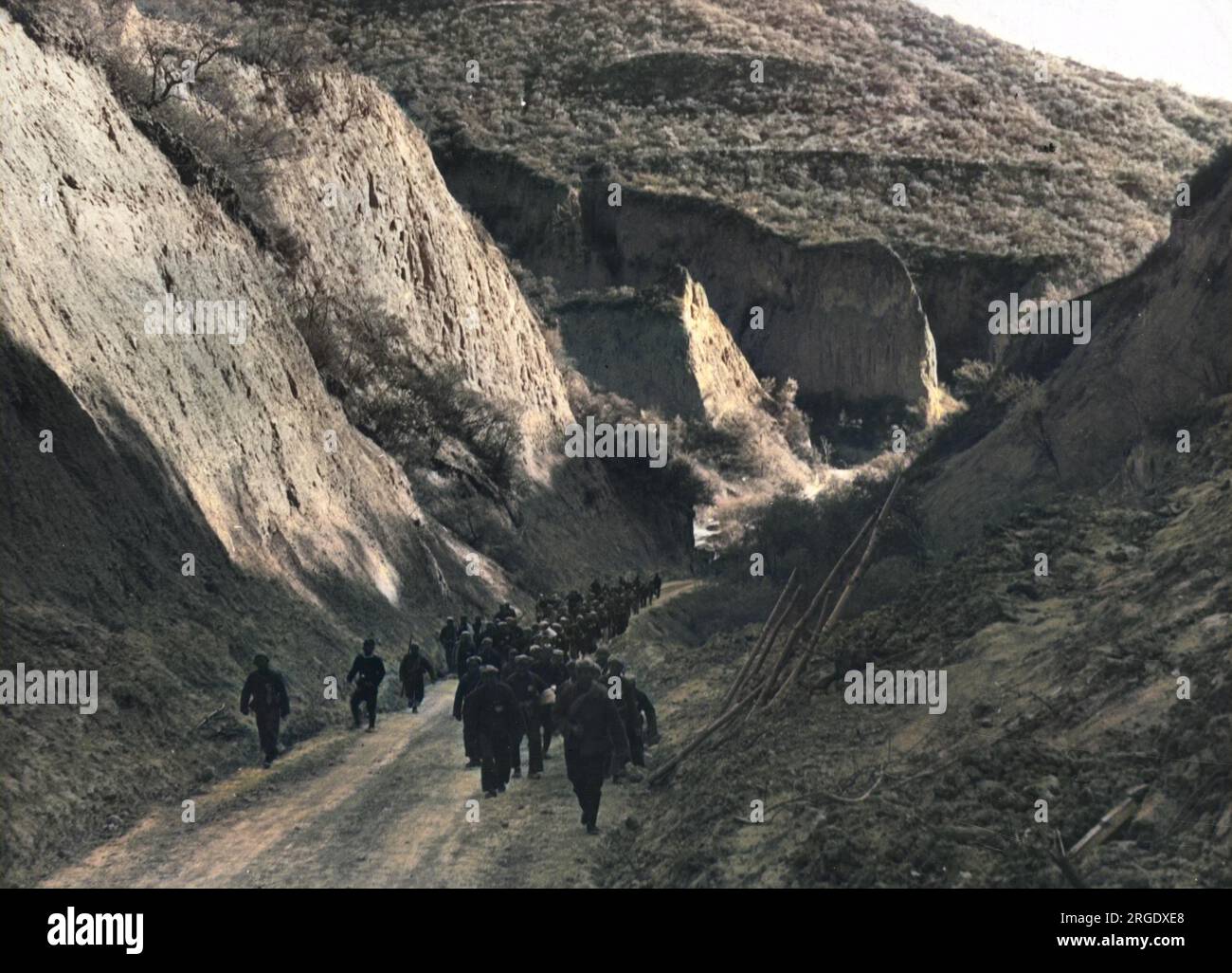 Chinese Communists pictured in rocky terrain during the Long March, a ...