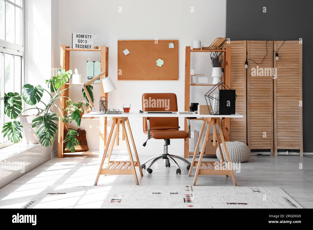 Interior of light office with workplace and shelving units Stock Photo ...