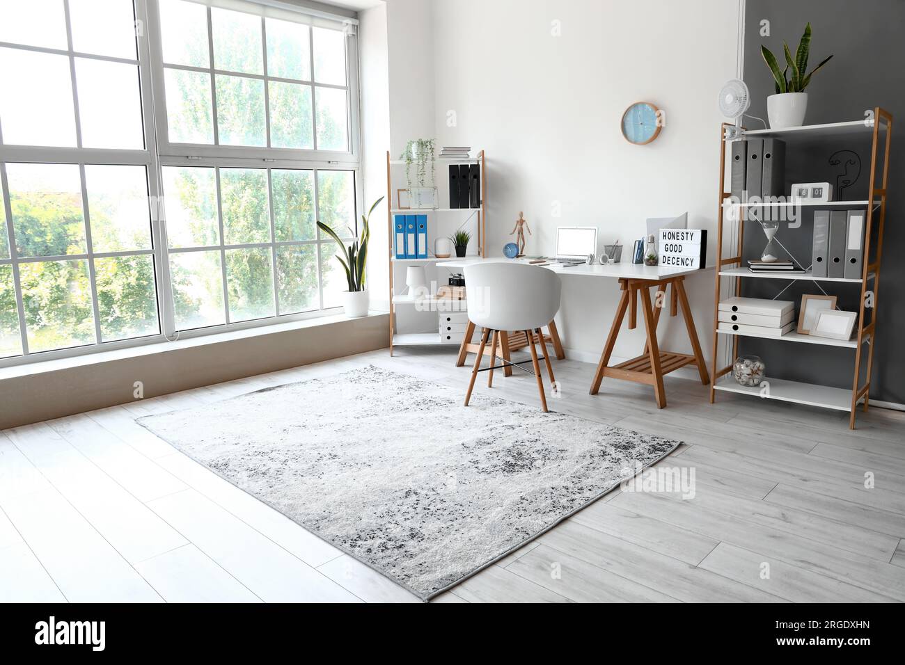 Interior of light office with modern workplace and shelving units Stock ...