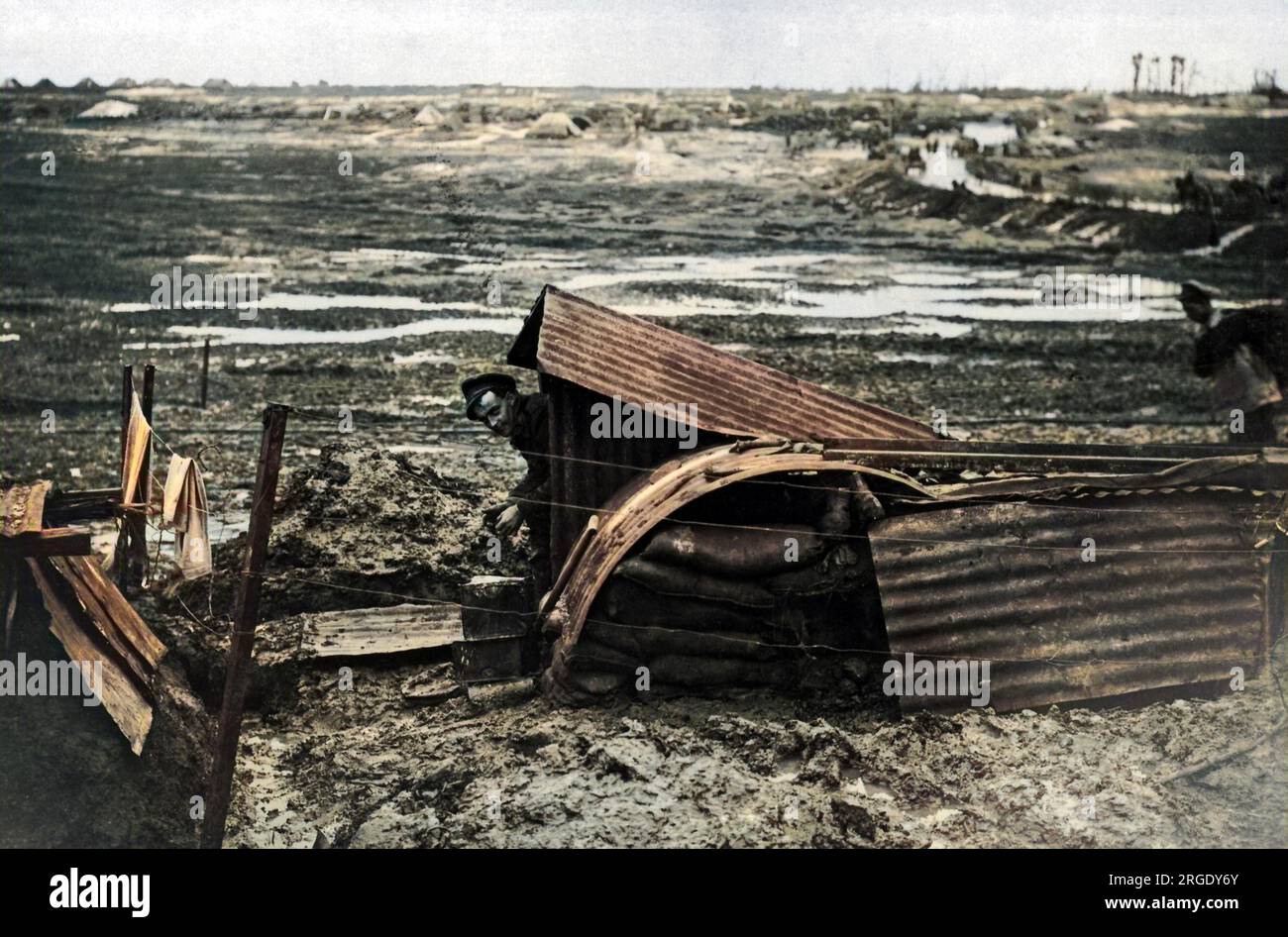 A British soldier looking out from his dugout, made partly of ...