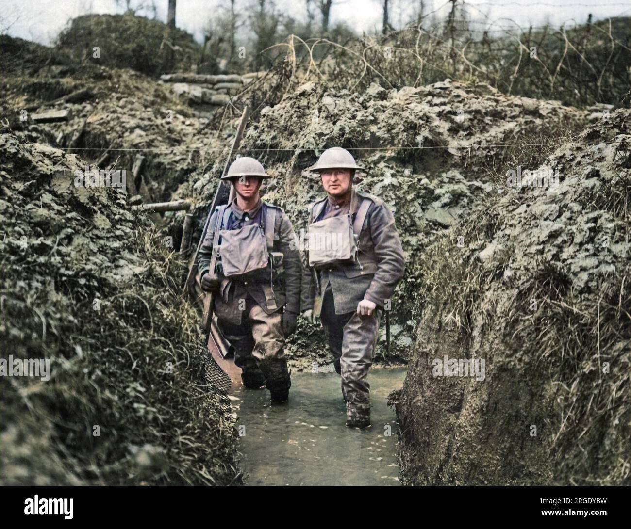 Two British soldiers in a flooded communication trench on the Western Front in France during ...