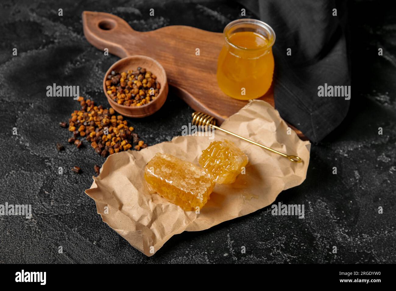 Paper sheet with fresh honeycombs and beebread on dark background Stock ...