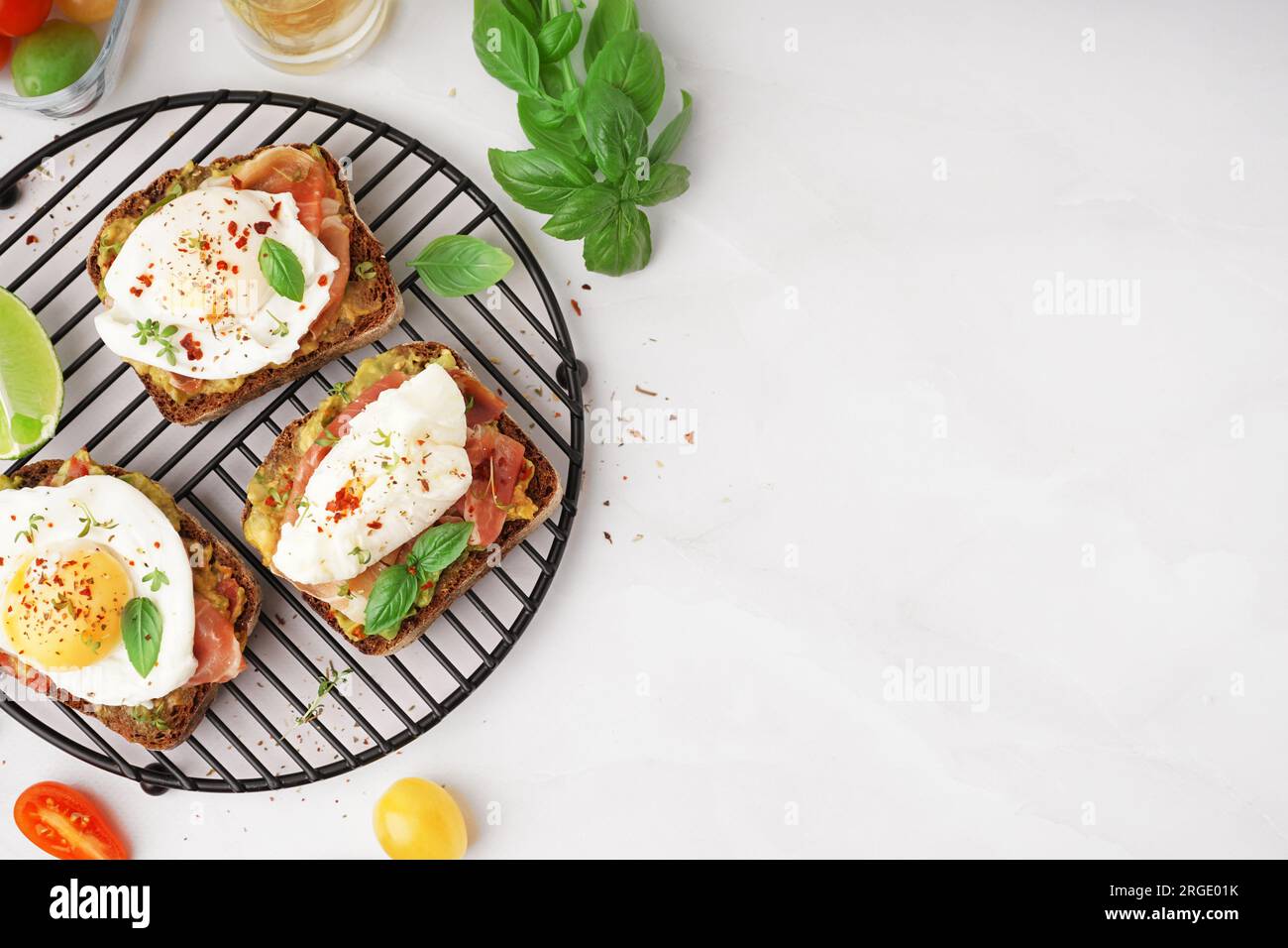 Grid of tasty sandwiches with egg on grey background Stock Photo - Alamy