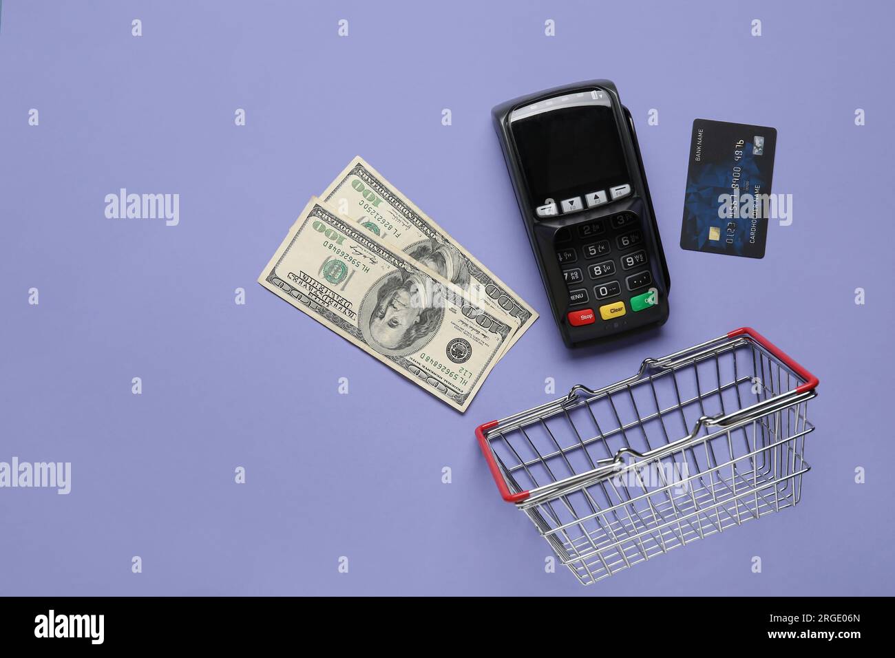 Shopping basket with payment terminal, dollar banknotes and credit card ...