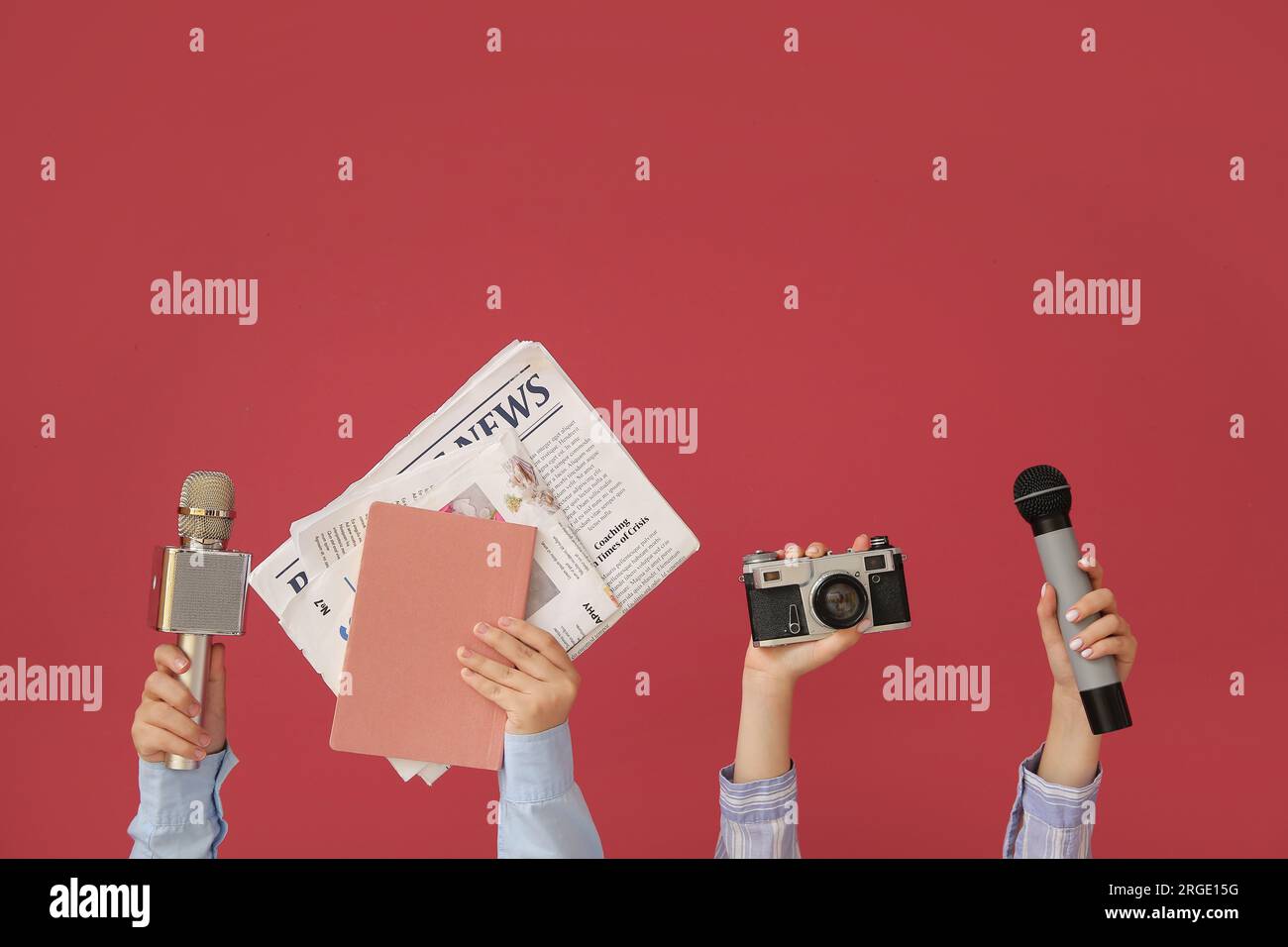Female hands with newspapers, microphones and photo camera on color ...