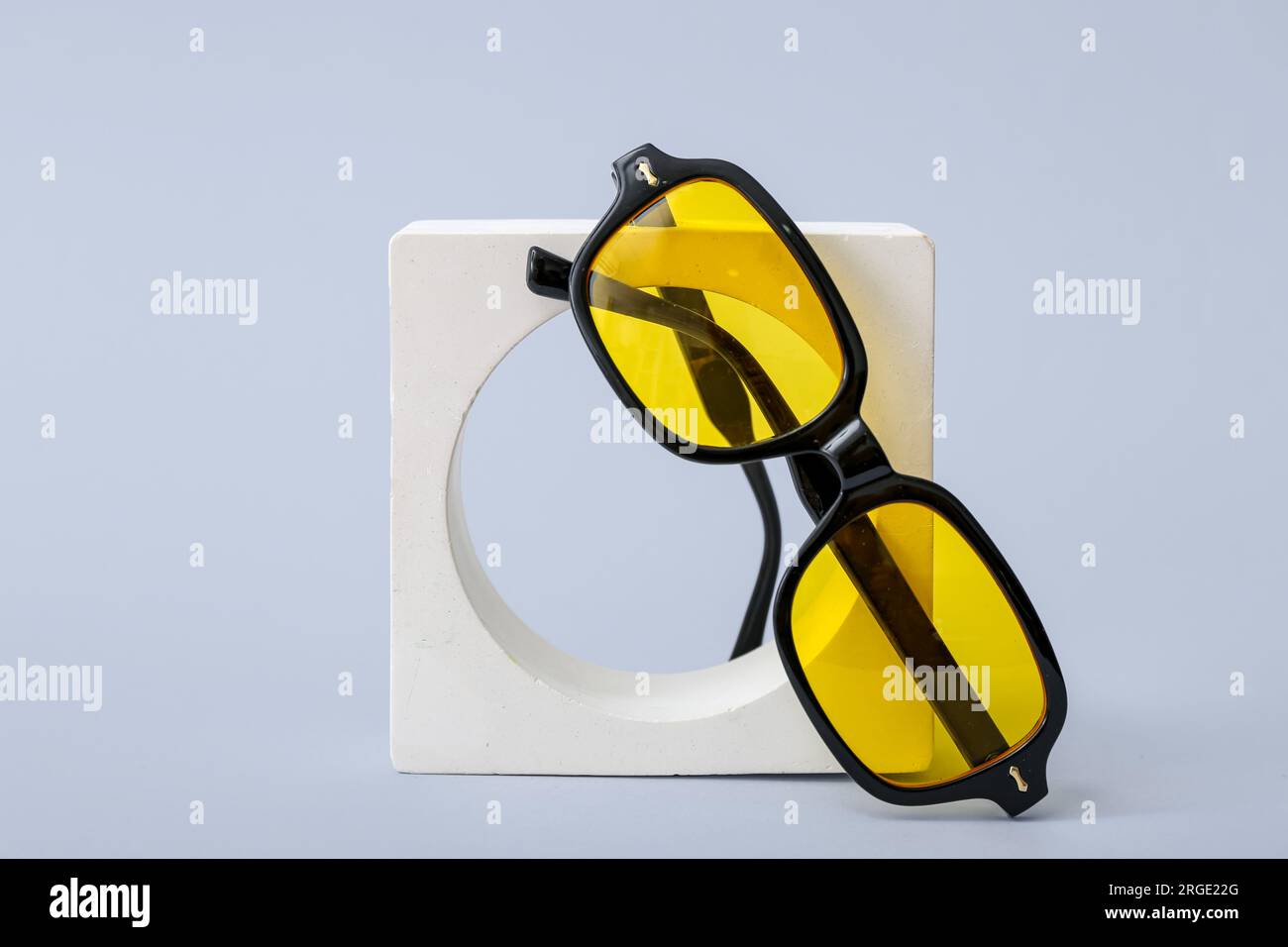 Decorative podium with stylish sunglasses on blue background Stock ...