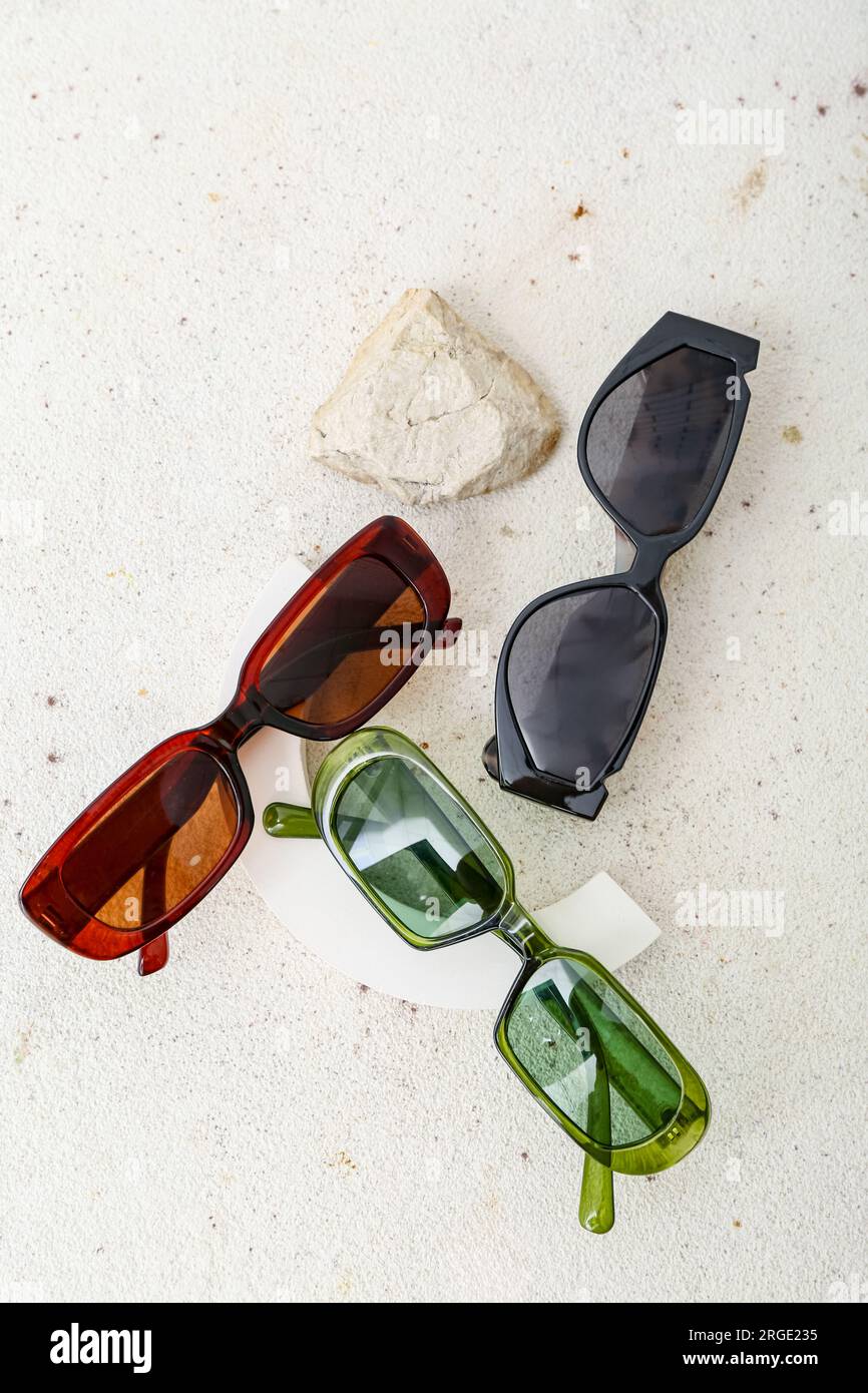 Decorative podium and stone with stylish sunglasses on white background ...