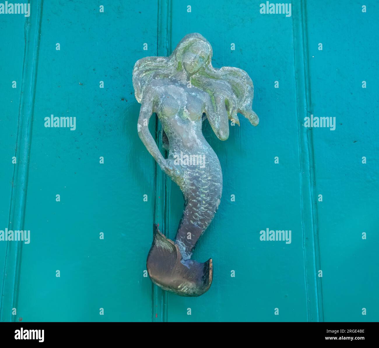 Brass door knocker depicting a mermaid on a turquoise painted door ...