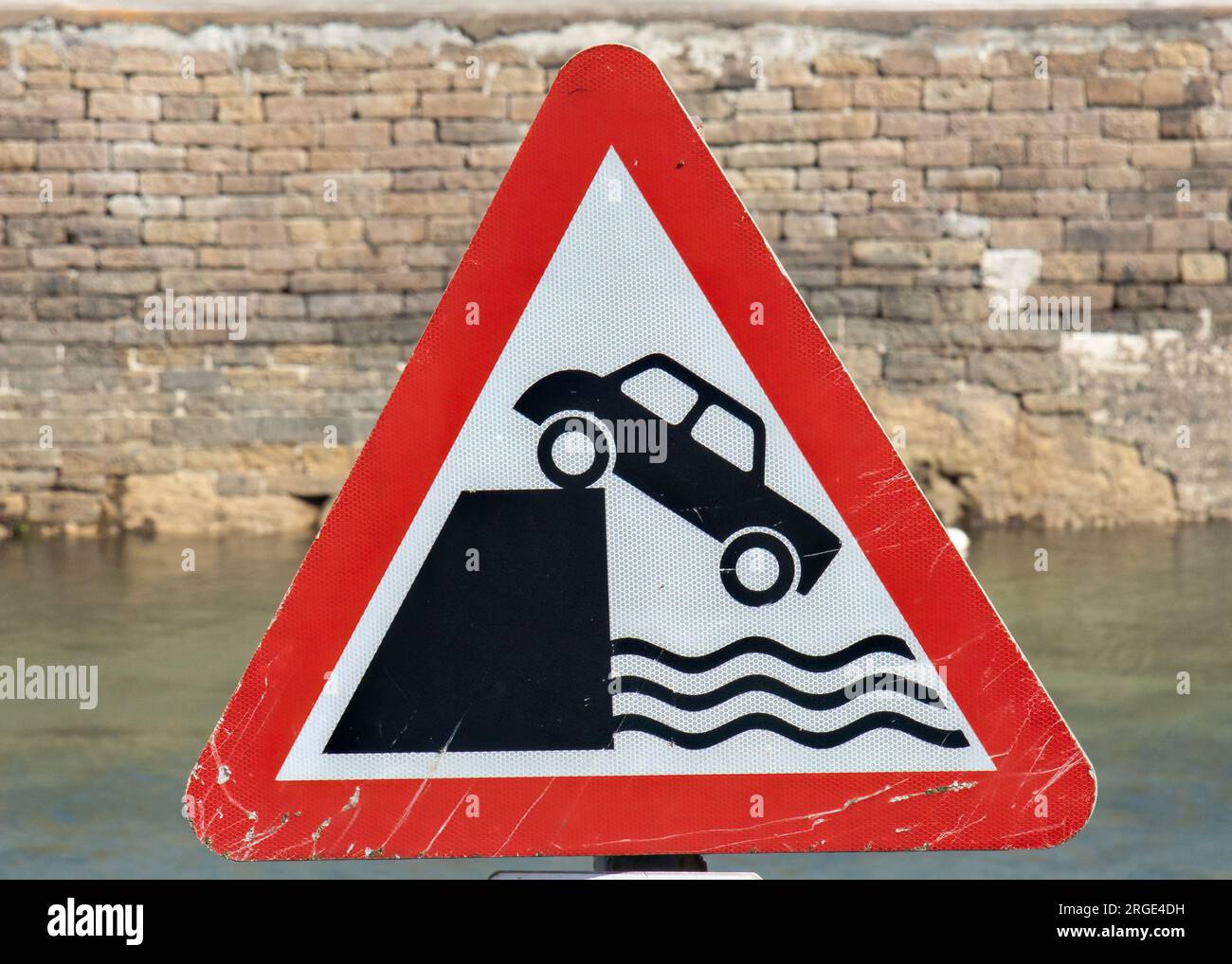 Warning of danger triangular road sign of harbour risk to vehicles ...