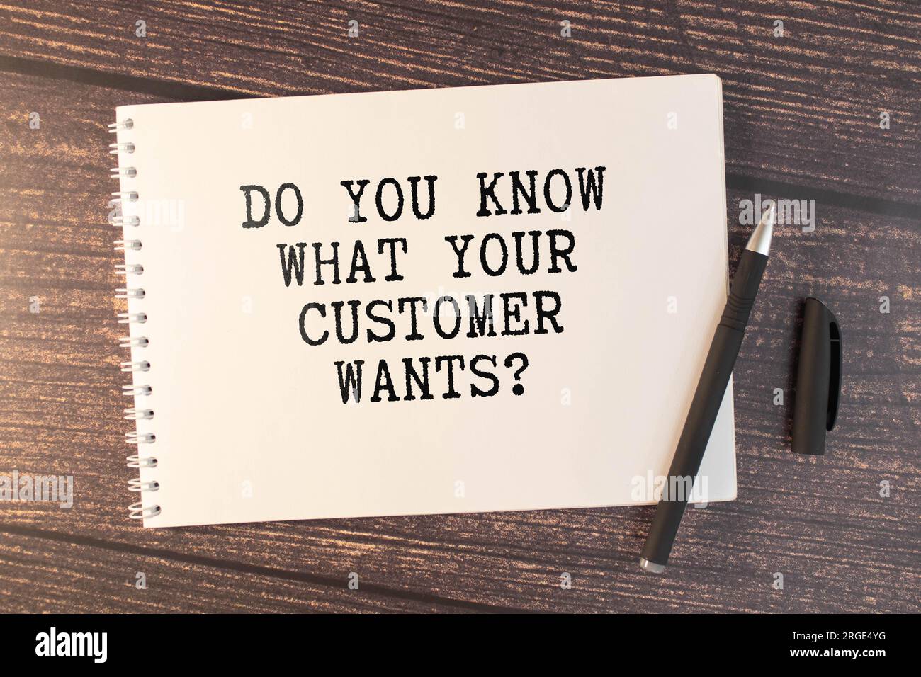 Notebook with text DO YOU KNOW YOUR CUSTOMER on a table with sticks ...
