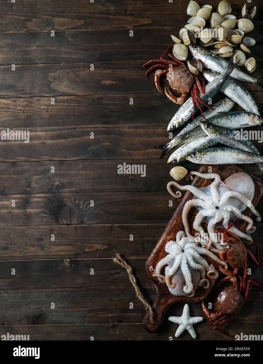 Seafood board with crabs, sardines and clams, fish and octopus on a ...