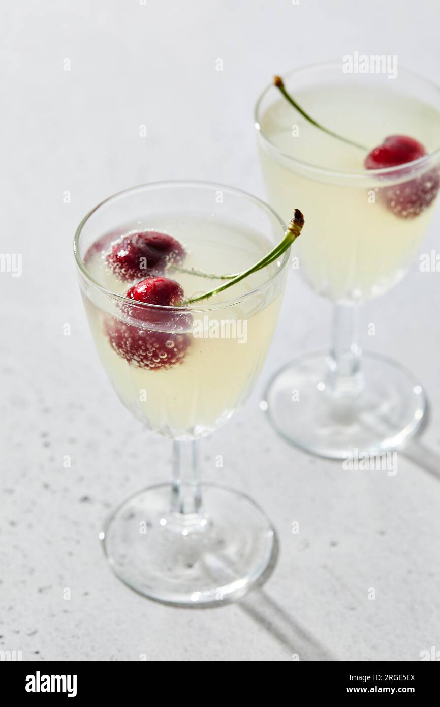 Lemon sparkling water with cherries Stock Photo - Alamy
