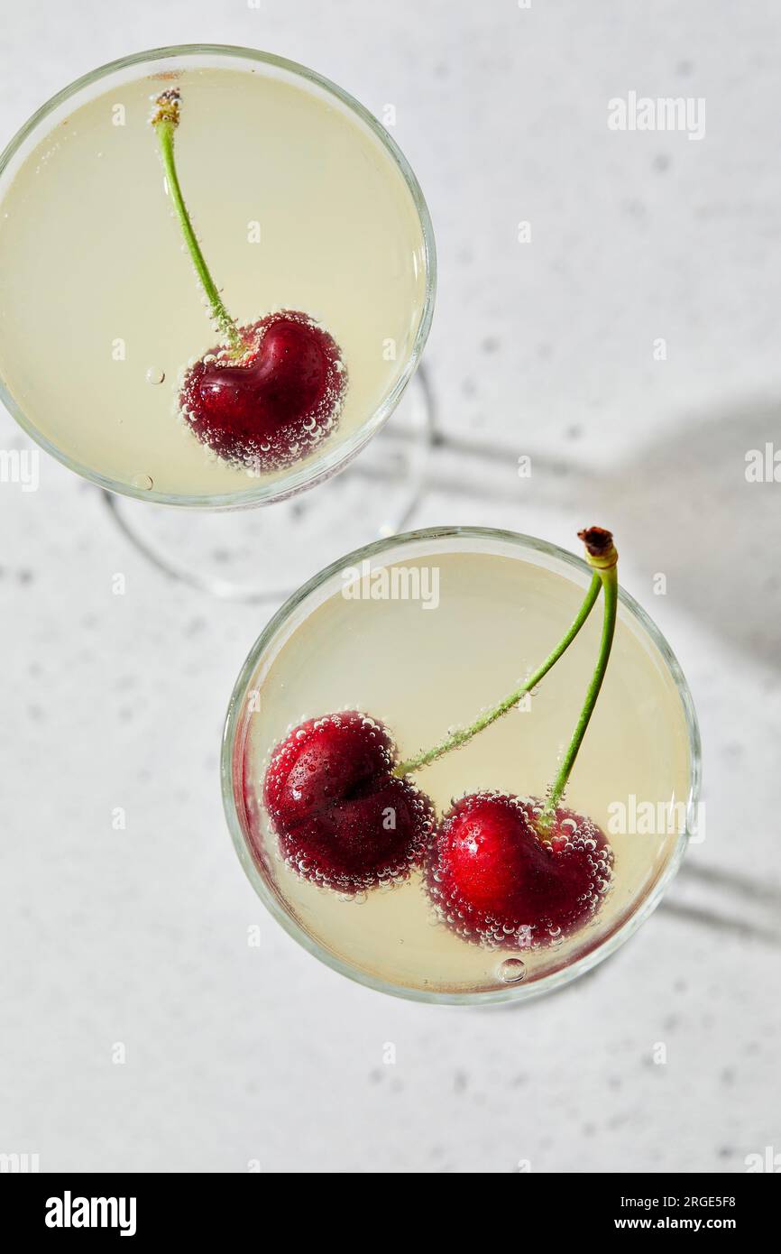 Lemon sparkling water with cherries Stock Photo - Alamy