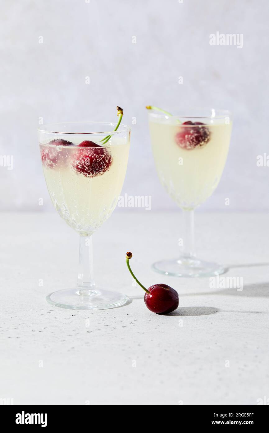 Lemon sparkling water with cherries Stock Photo - Alamy