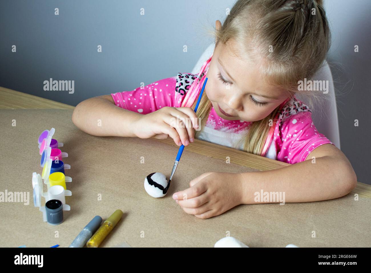Cute Caucasian preschool girl is showing an art she made. Painting ...