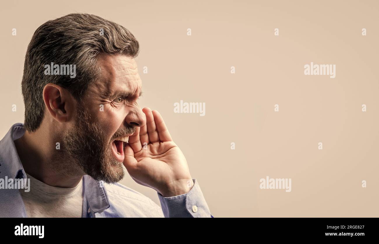 man with shouting face isolated on studio background, copy sace banner ...