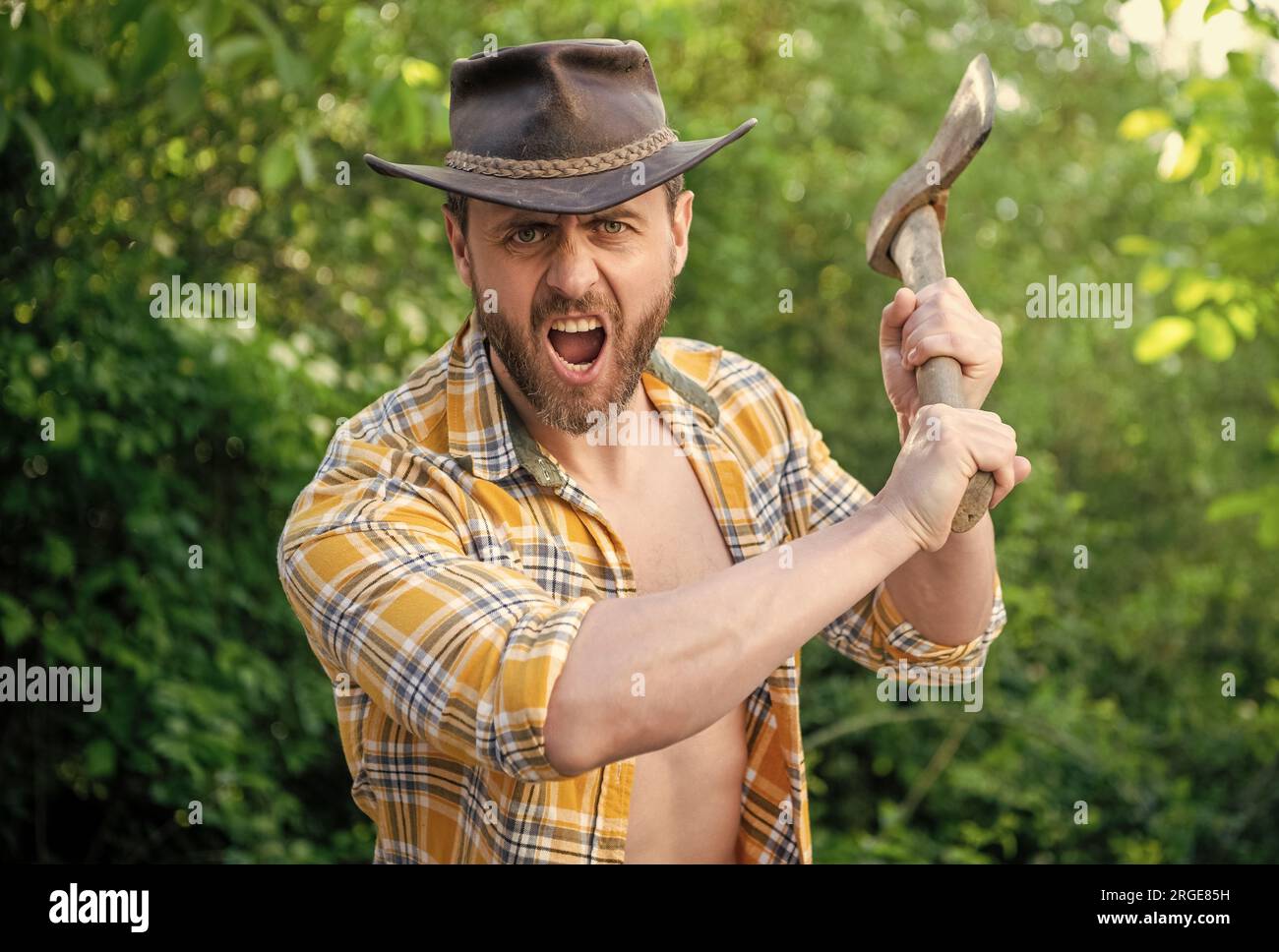 angry lumberjack shout with axe outdoor. photo of angry lumberjack with ...
