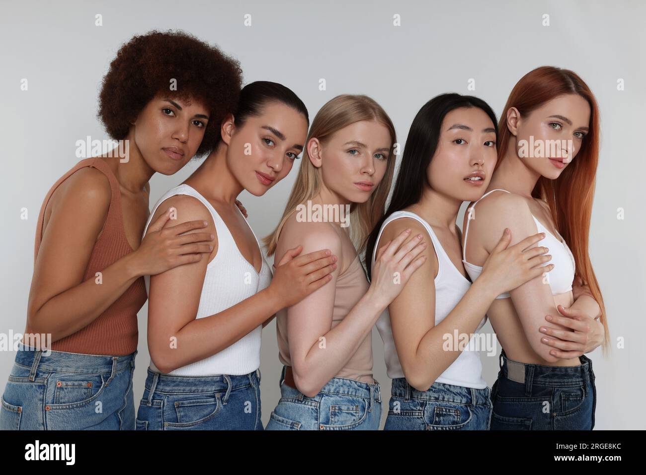 Portrait of beautiful young women on light grey background Stock Photo ...