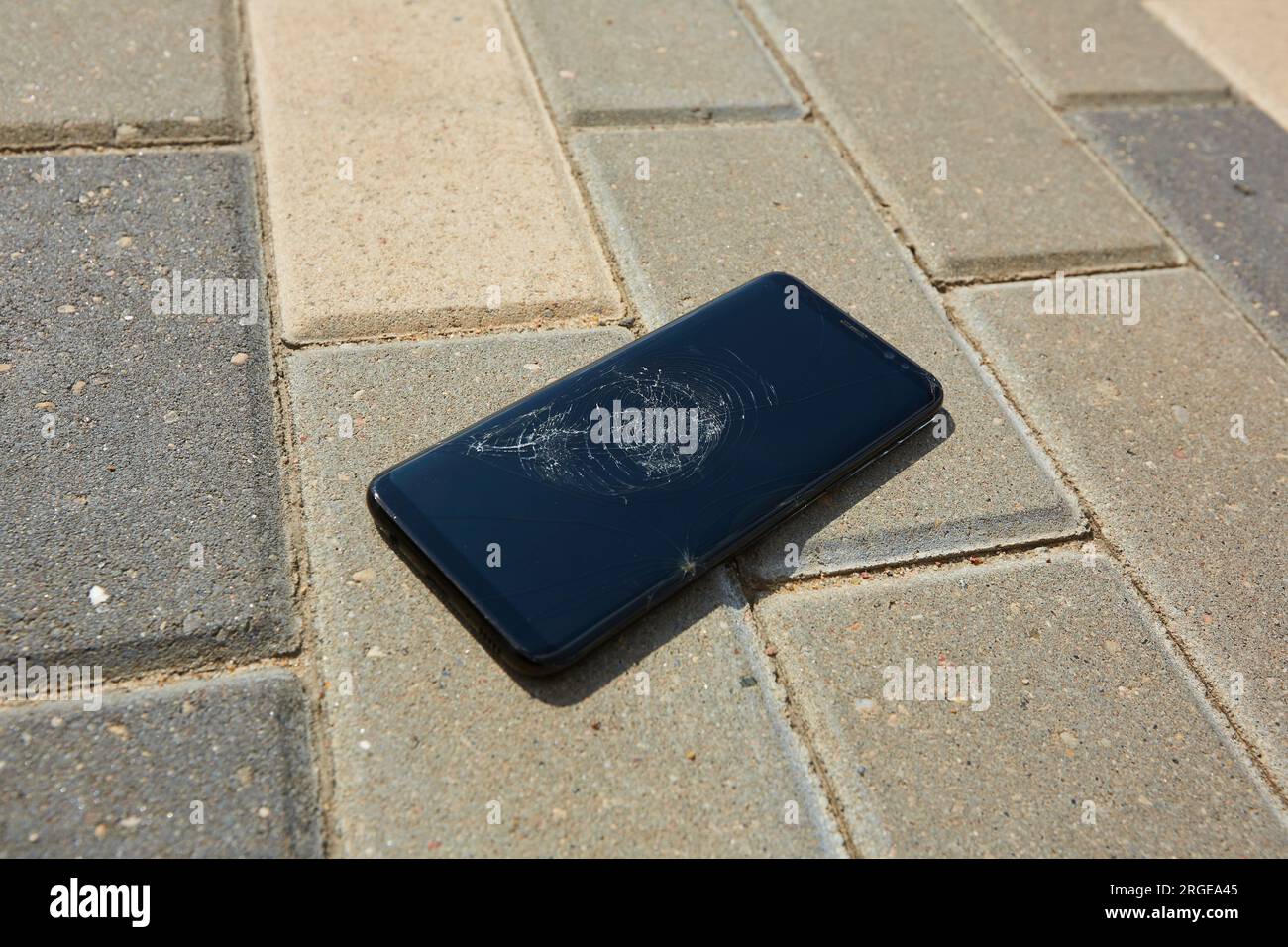 mobile phone fell and crashed on sidewalk. Smartphone with a broken ...