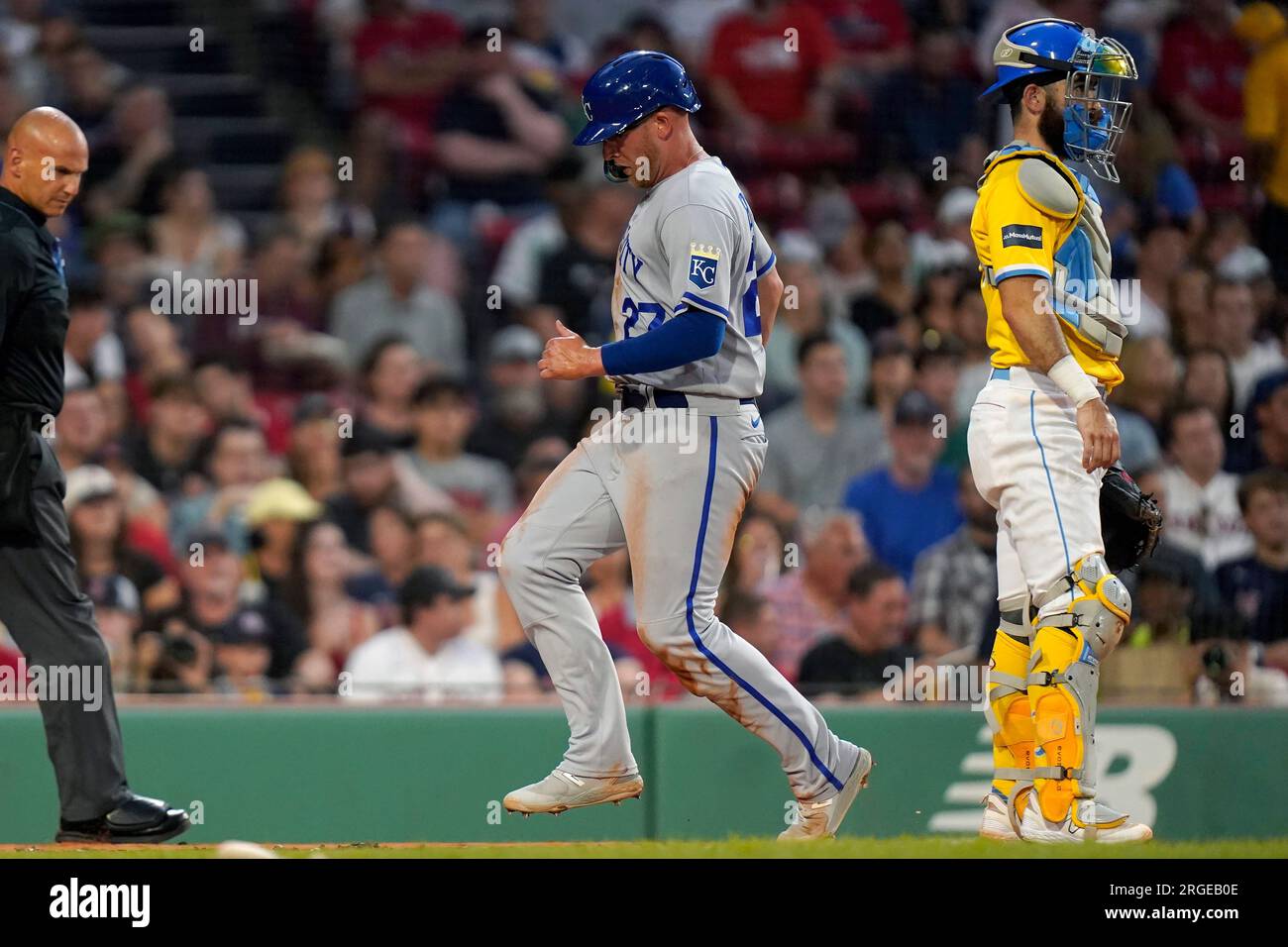 Kansas City Royals' Matt Beaty, left, scores on a sacrifice fly by Kyle ...