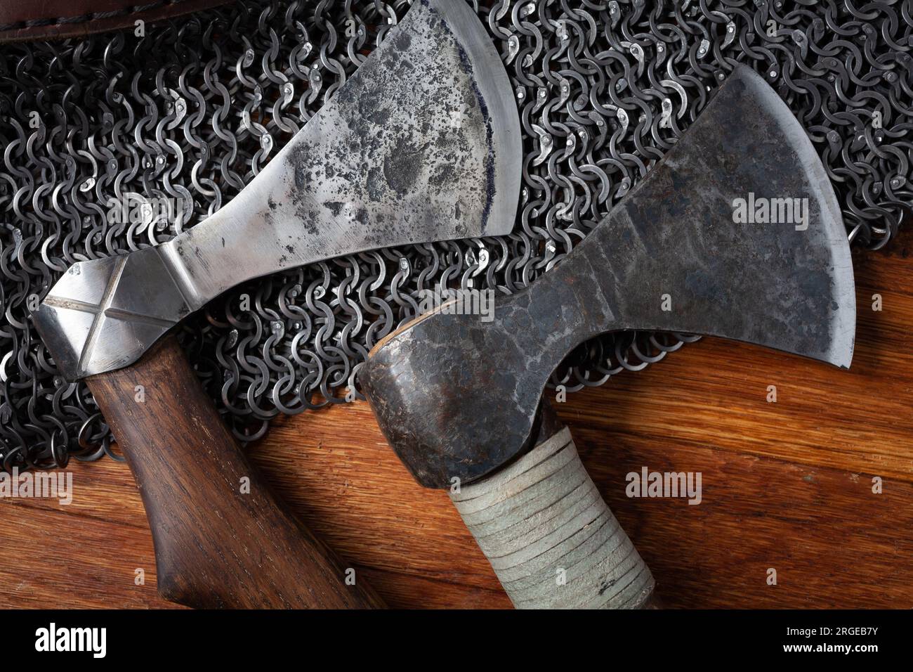 Medieval battle axes on chain mail armor background Stock Photo - Alamy
