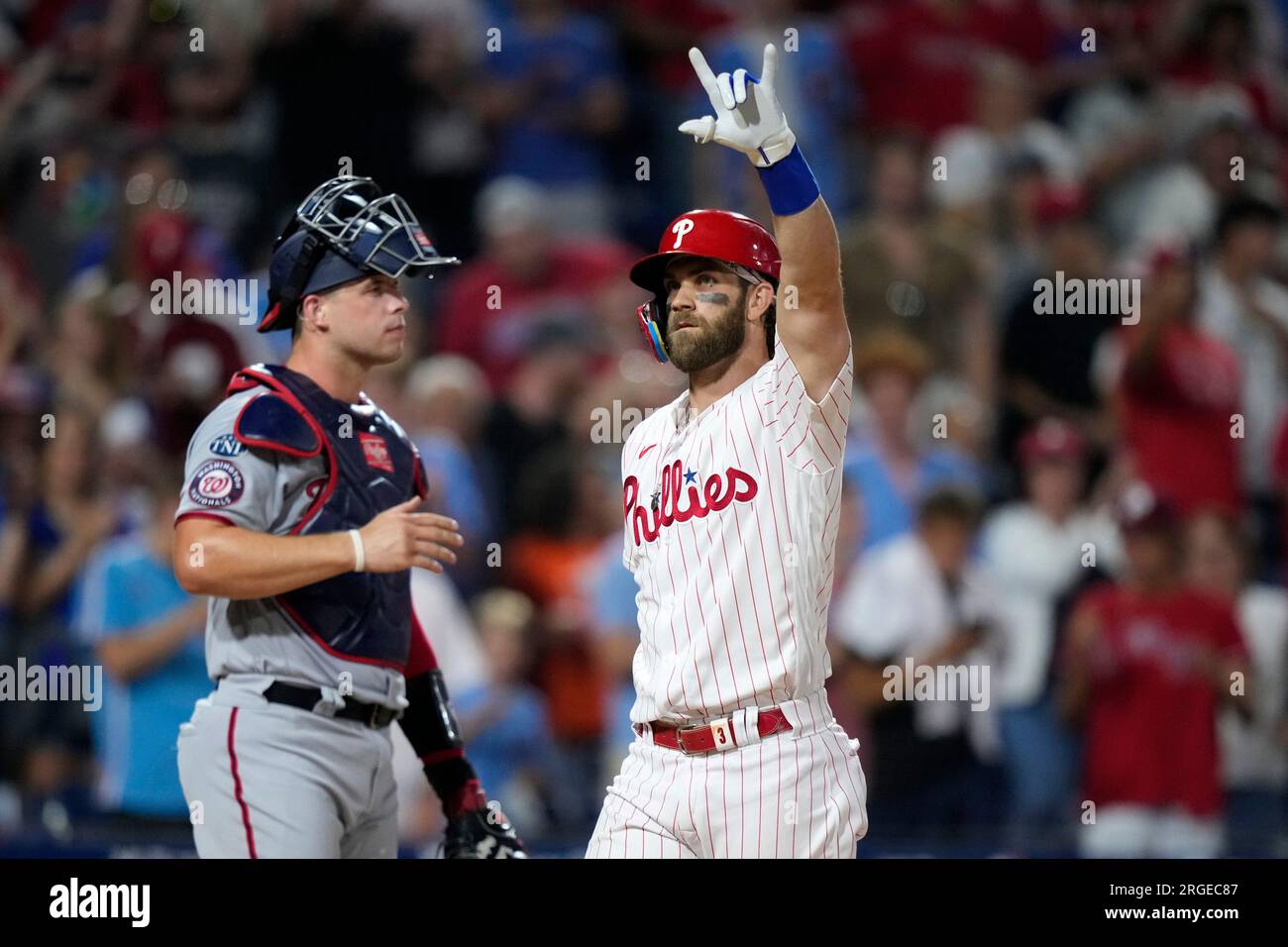 Philadelphia Phillies' Bryce Harper, right, reacts past Washington ...
