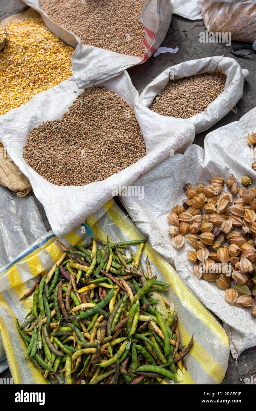 A selection of grain seeds and vegetables for sale at a stall within ...