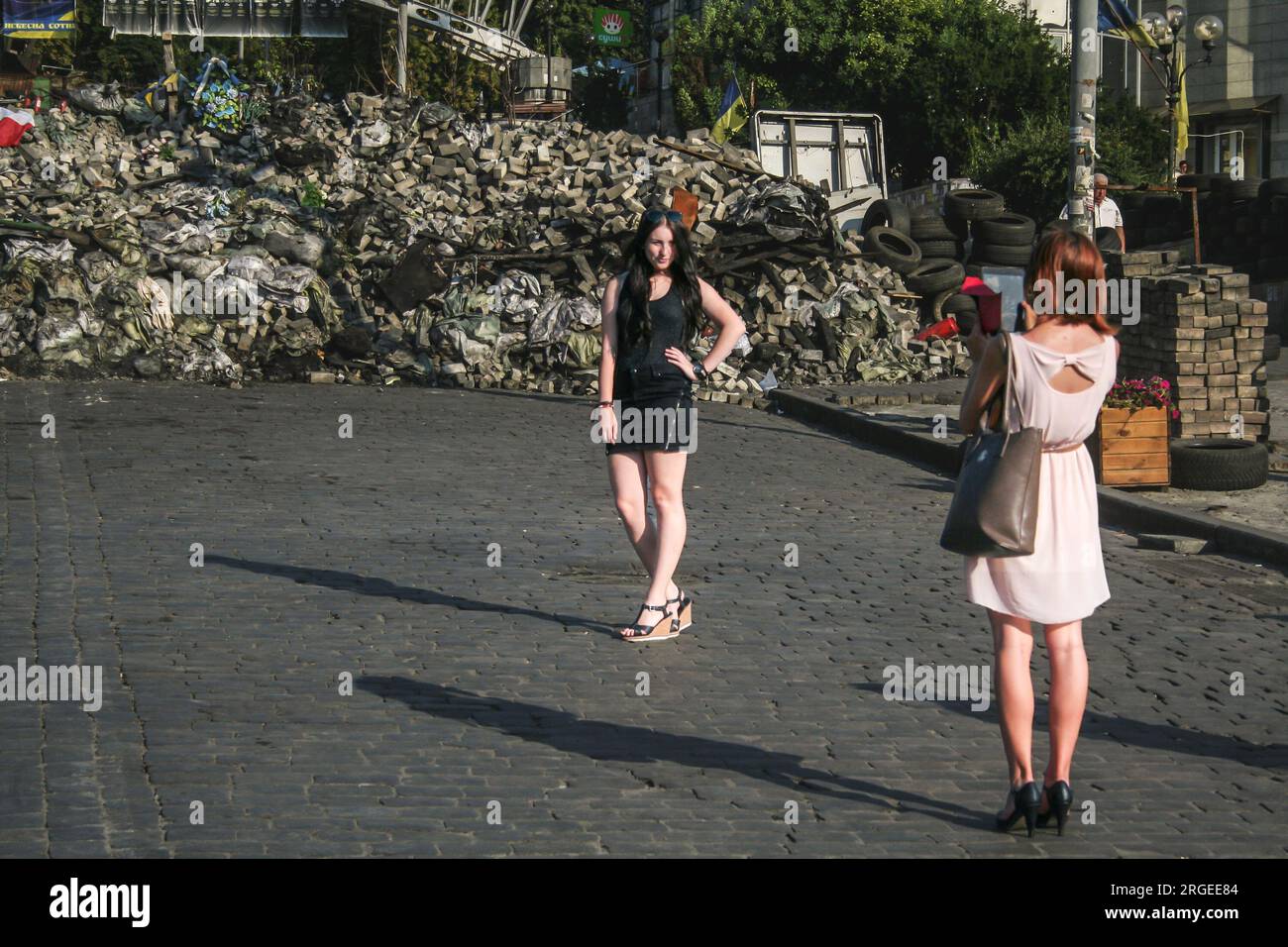 Picture of two girls taking pictures in front of one of Maidan ...