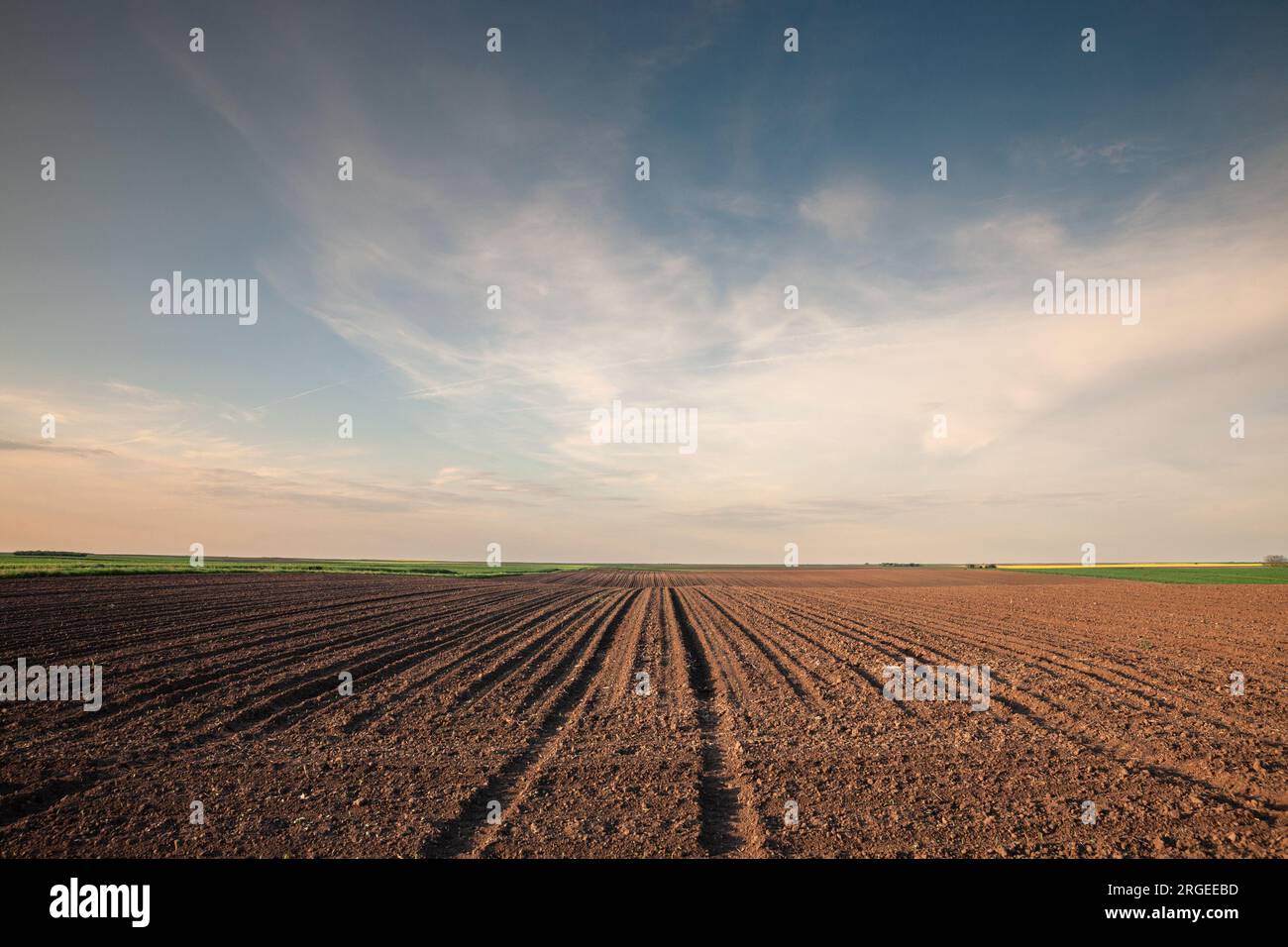 Picture of a landscape from Serbia, with a plowed field in front. in ...