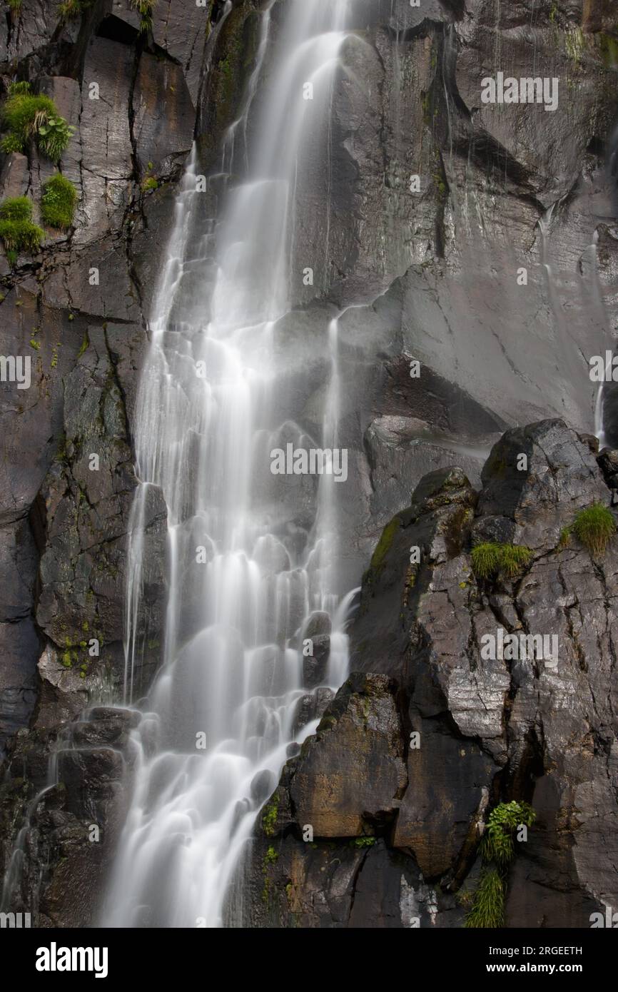 Close up of small waterfall cascading down a wet rocky cliff Stock ...
