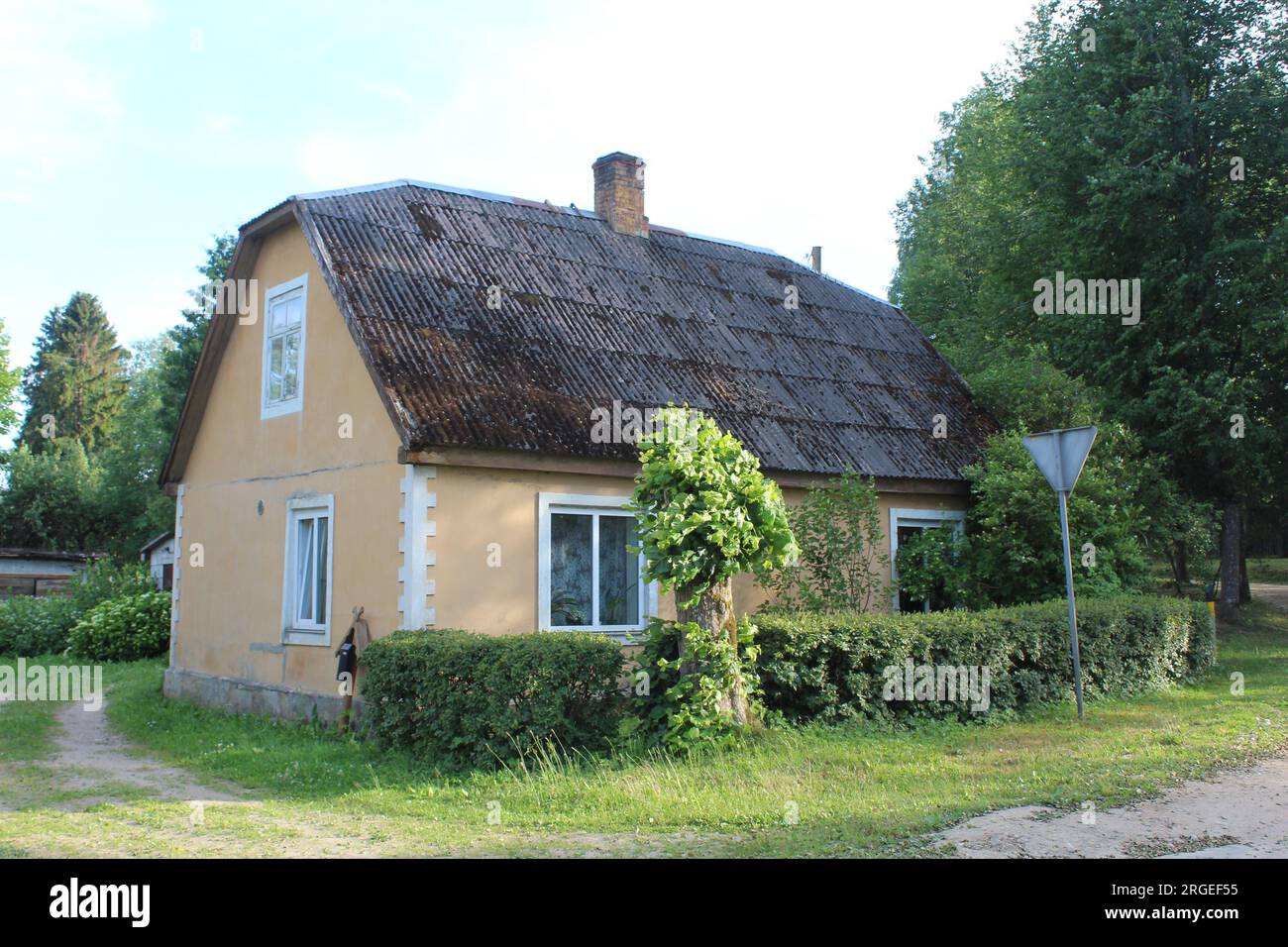Traditional Latvian village home in light orange in Akniste Stock Photo ...