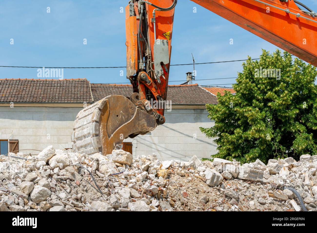 Excavator on building demolition site Stock Photo - Alamy