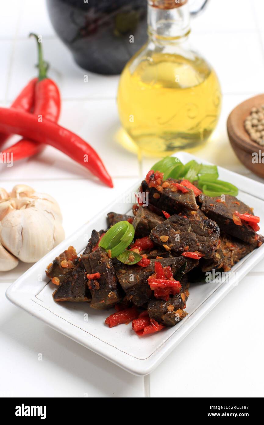 Fried Lung with Spicy Red Sauce or Paru Goreng Balado, on White Table ...