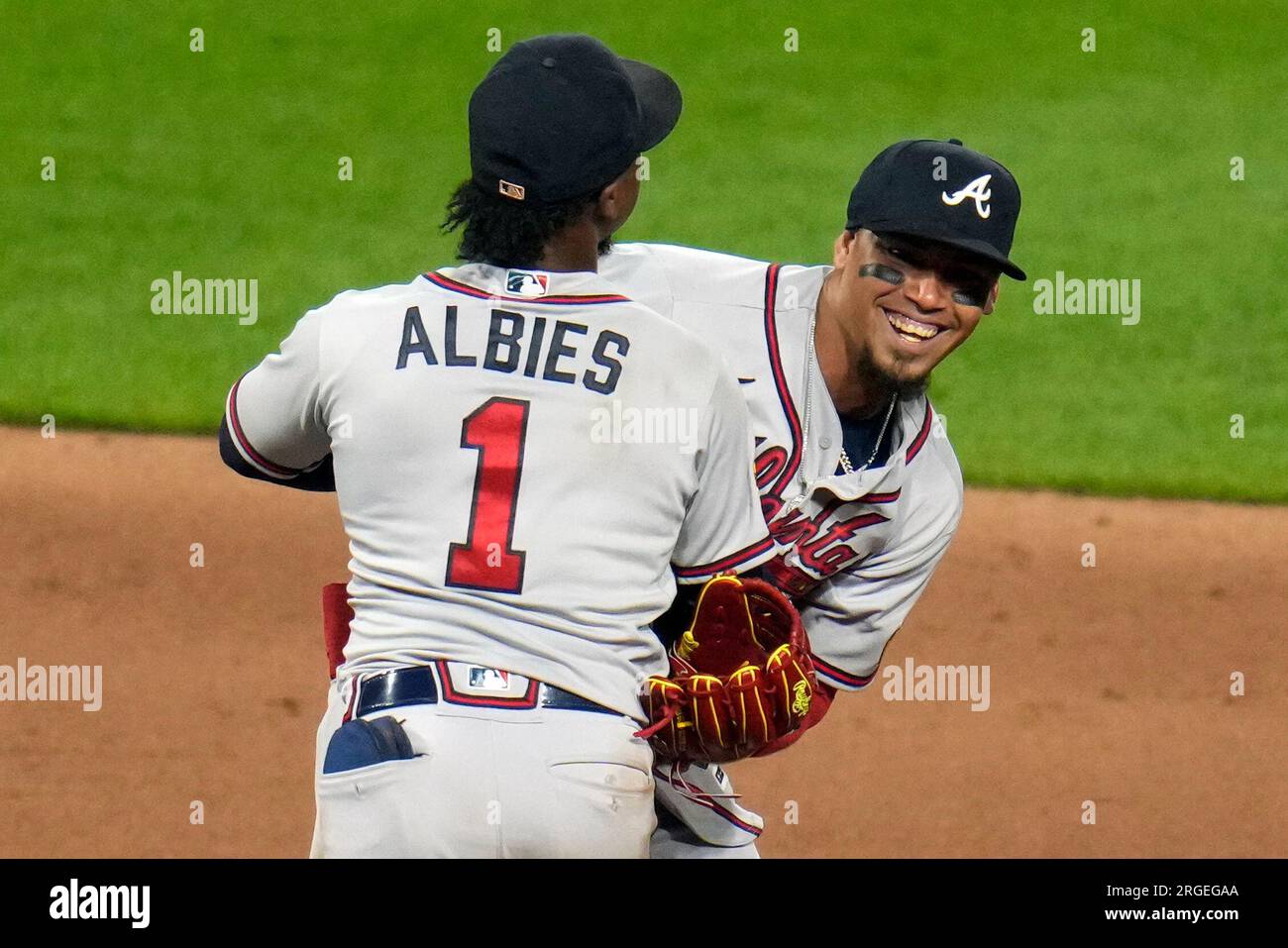 Atlanta Braves' Orlando Arcia, right, and Ozzie Albies (1) celebrate after getting the final out ...
