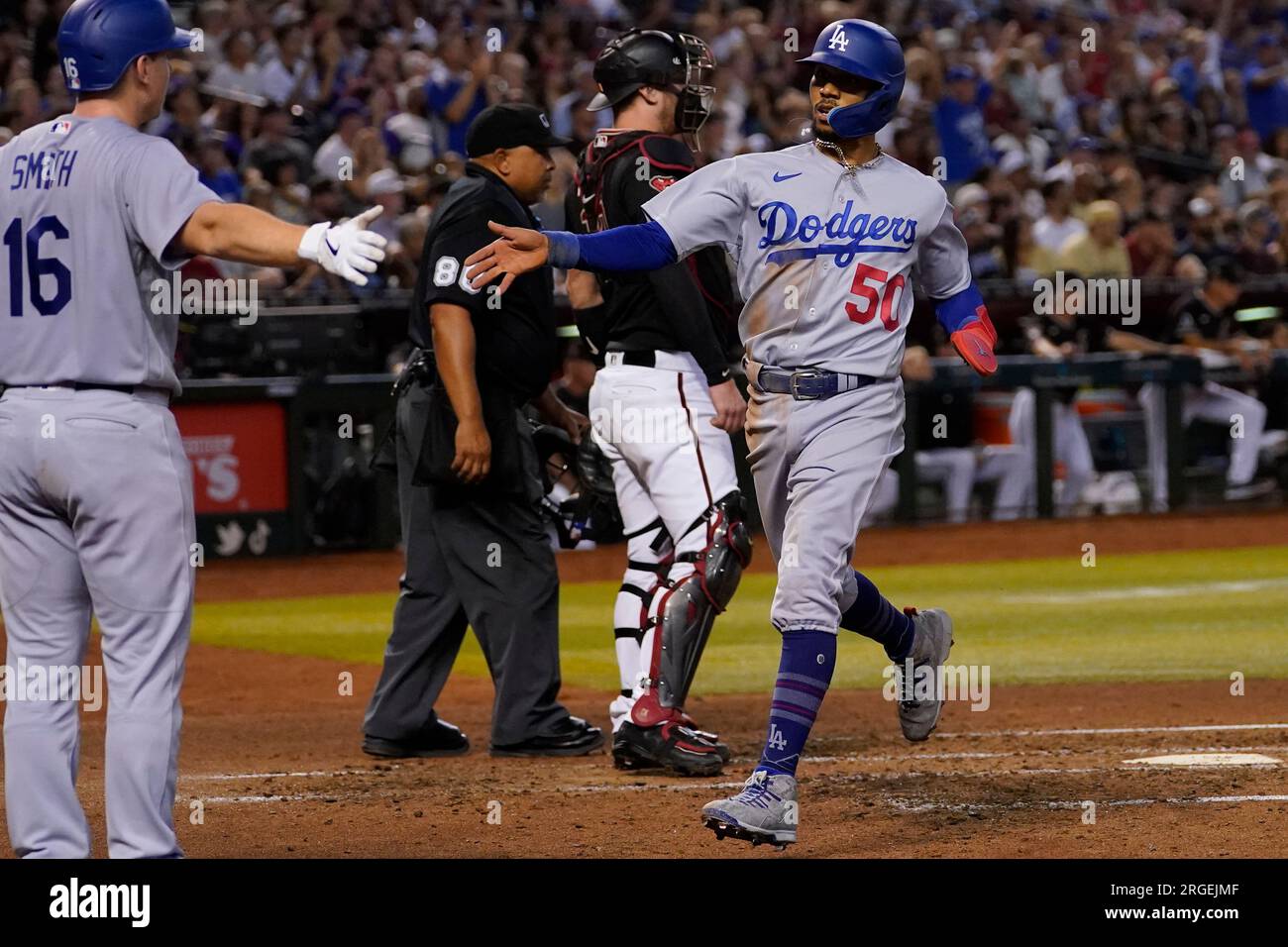 Los Angeles Dodgers' Mookie Betts (50) scores on a double hit by ...