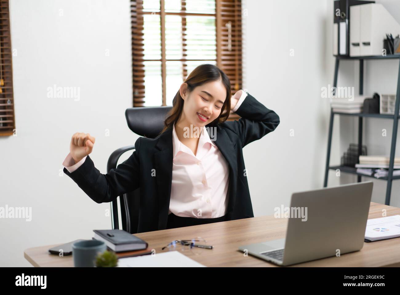 Businesswoman raise arms to stretching for relaxation after exhausted ...