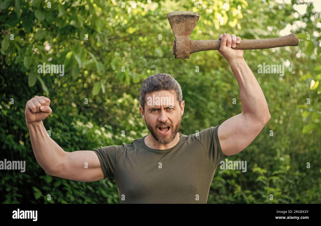 aggressive man with axe wearing shirt. aggressive man with axe outdoor ...