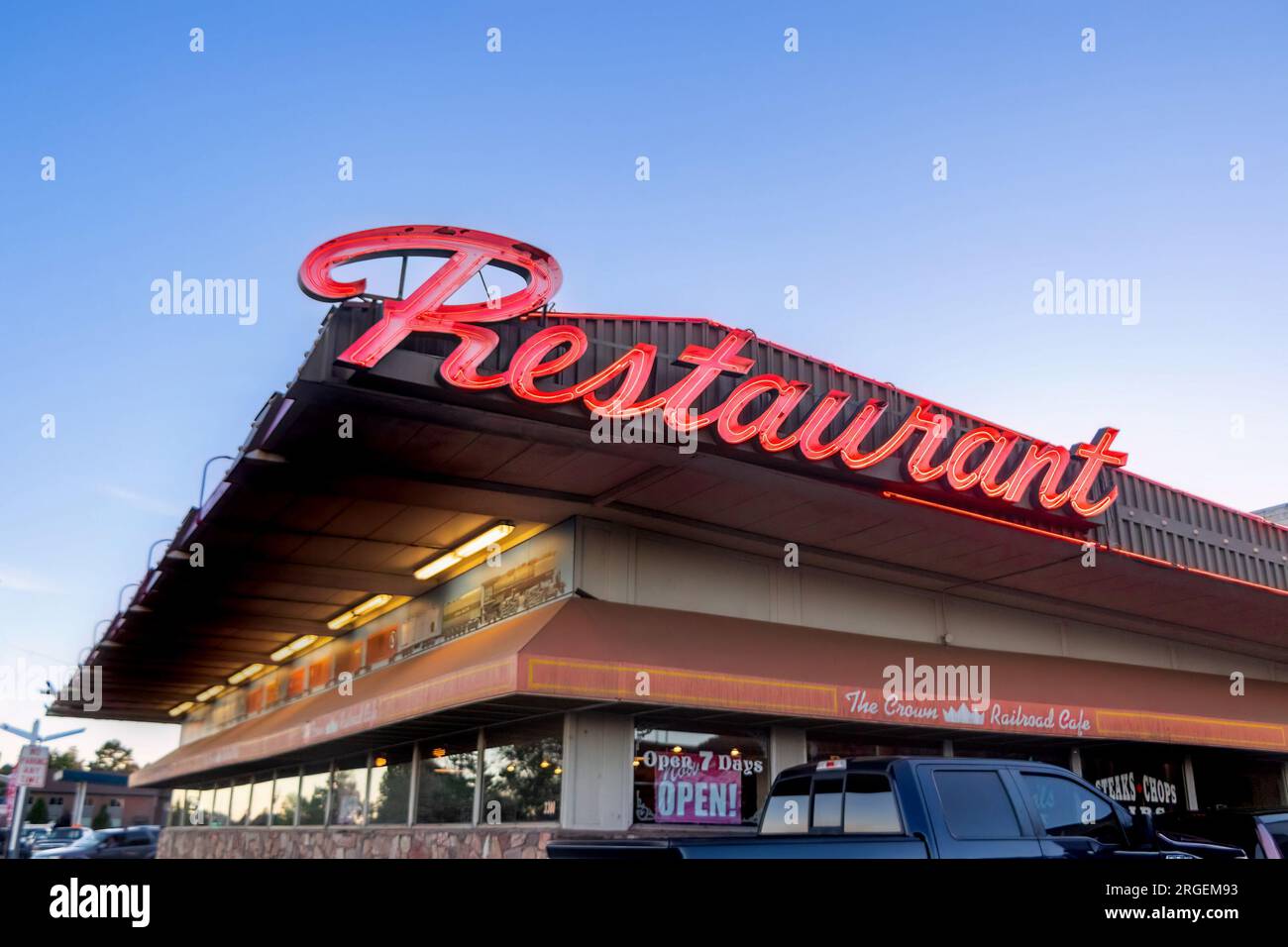 A classic American diner with a large neon 'Restaurant' sign, featuring ...