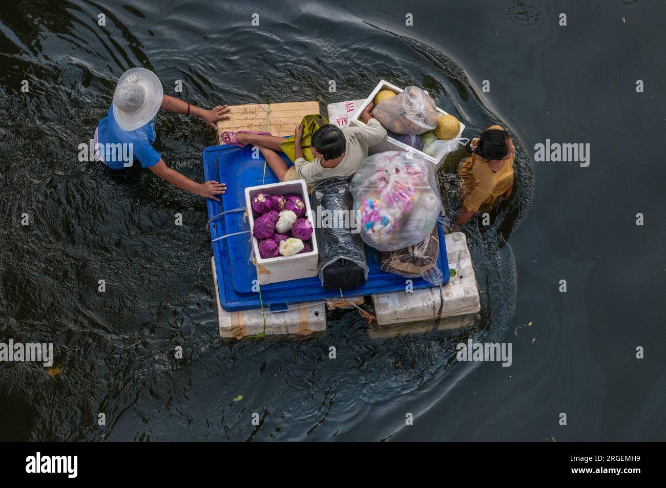 overhead of Thai refugees on makeshift raft moving through dangerous ...