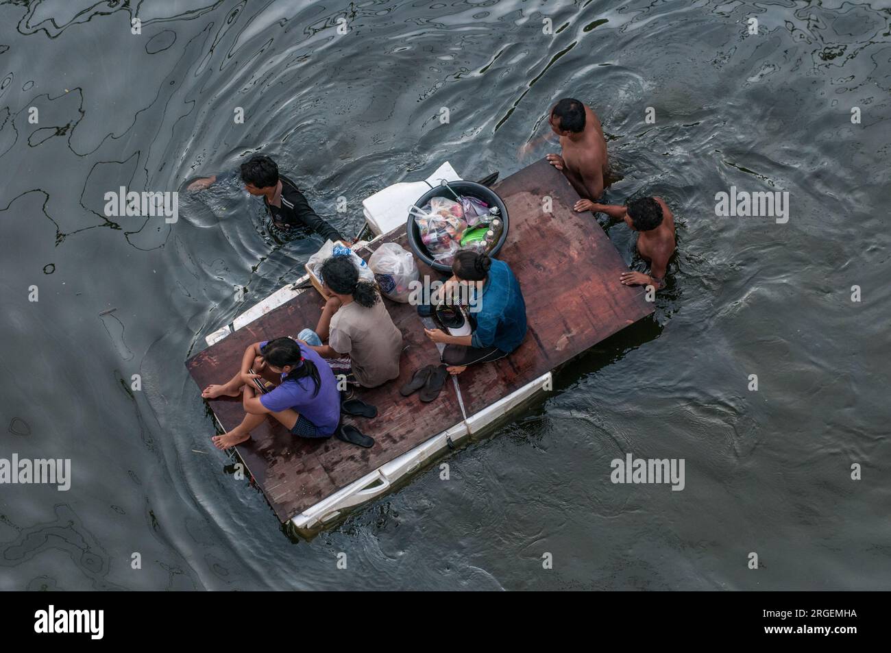 overhead of Thai refugees on makeshift raft moving through dangerous ...