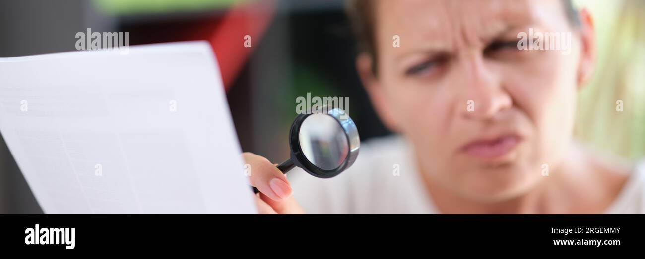 Woman using magnifying glass to read text on paper, eye diseases and ...