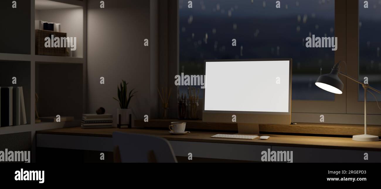 A modern, dark home workspace with a computer white screen mockup on a ...