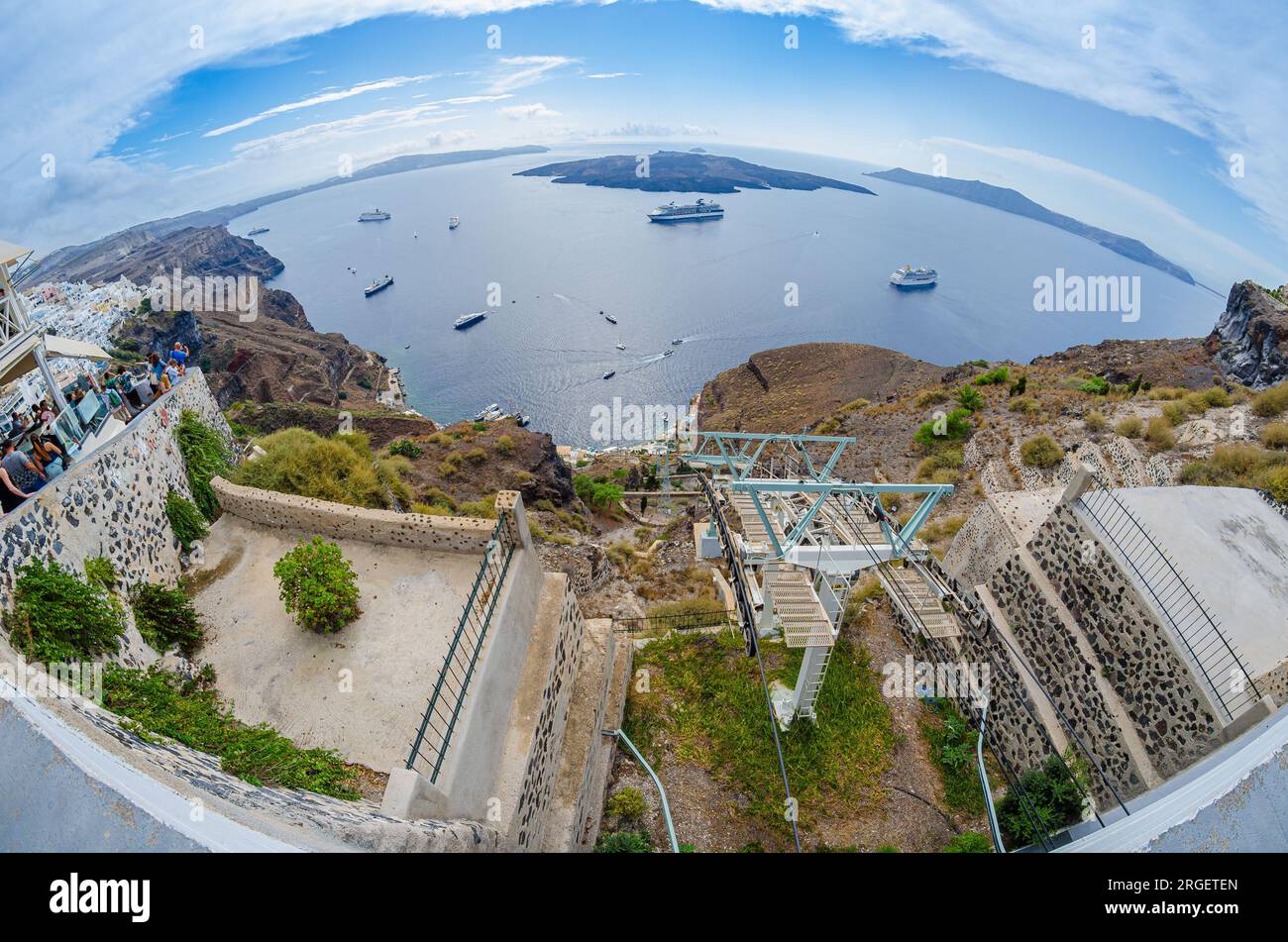 Panoramic view of the Oia village and cable cart on Santorini island in ...